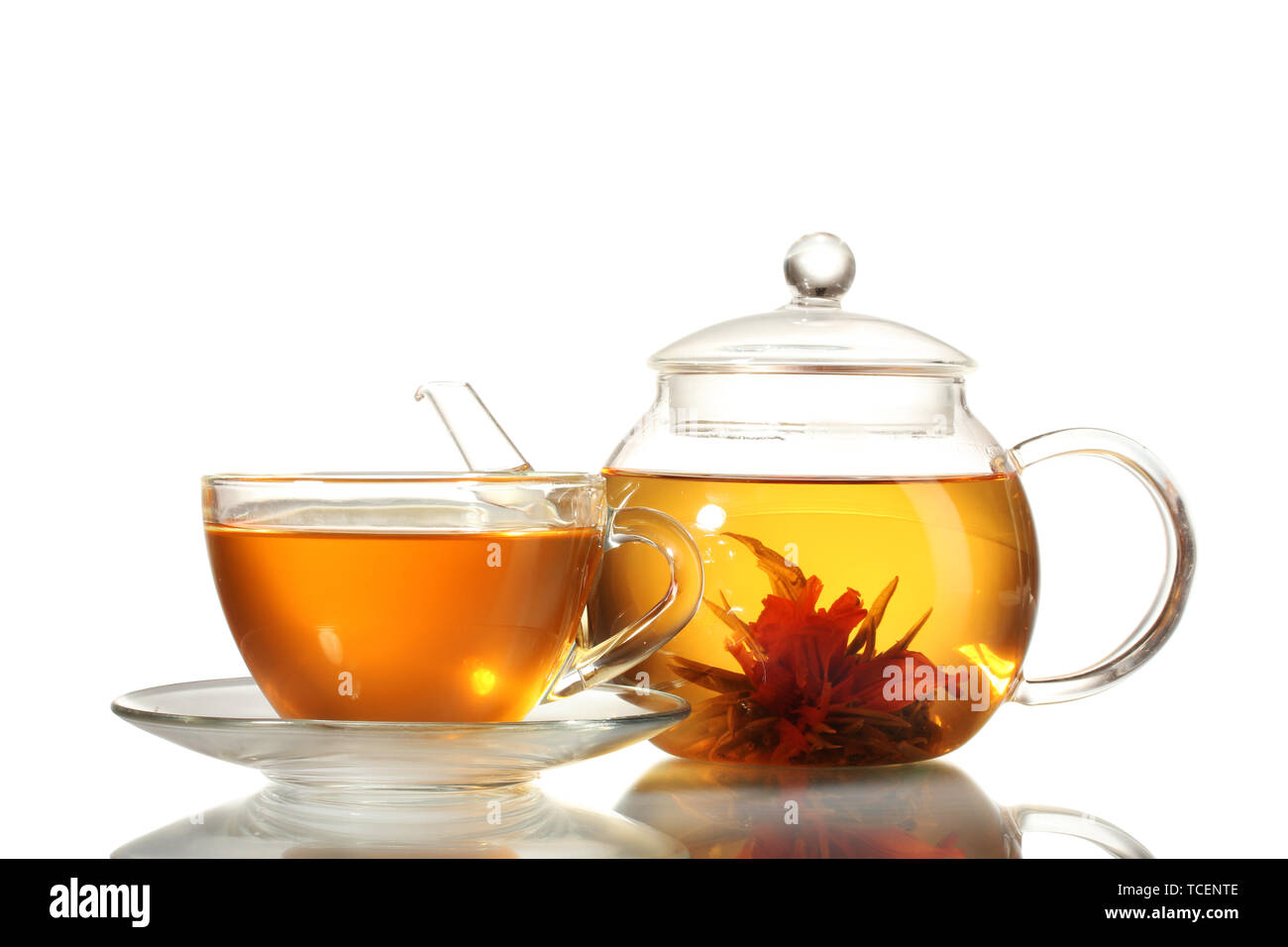 exotic green tea with flowers in glass teapot and cup isolated on white ...