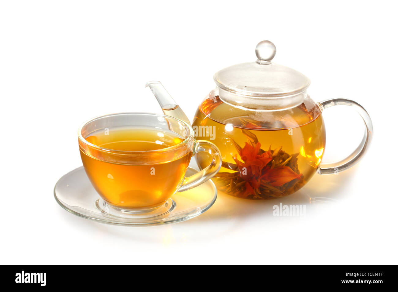 exotic green tea with flowers in glass teapot and cup isolated on white ...