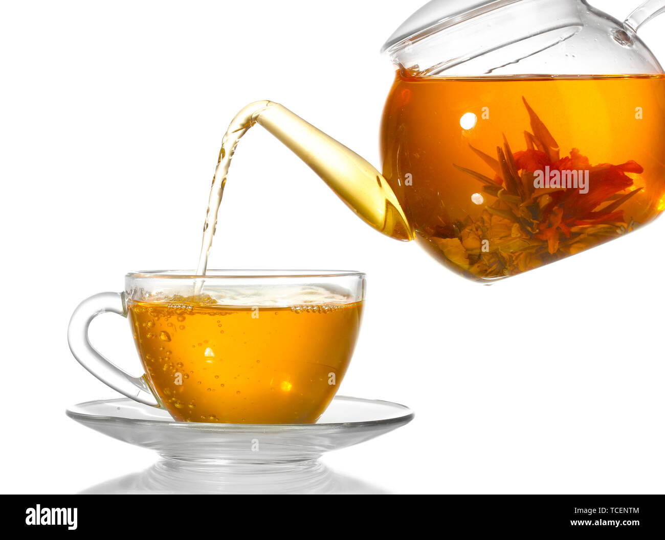exotic green tea with flowers in glass teapot and cup isolated on white ...