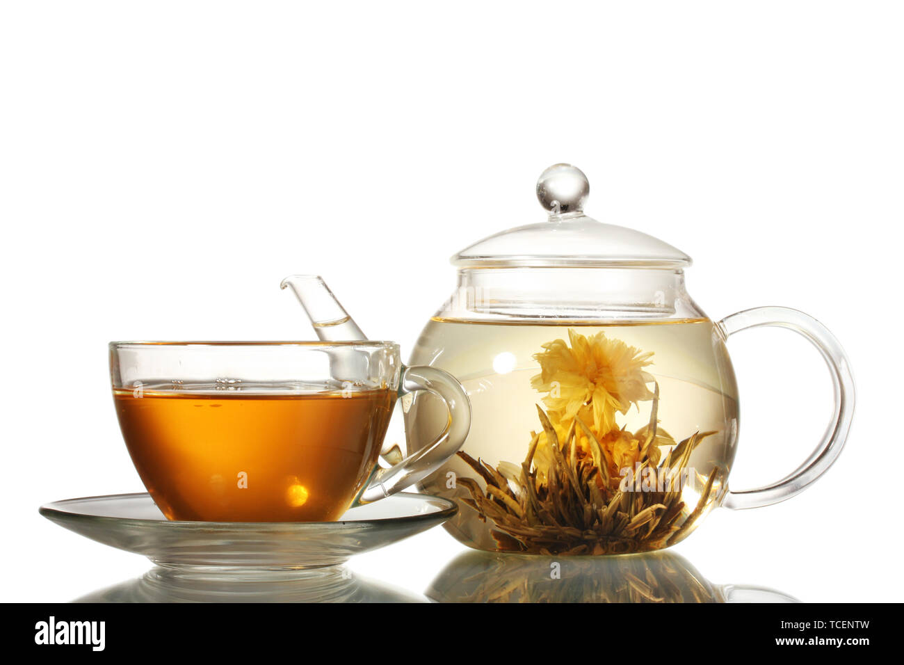 exotic green tea with flowers in glass teapot and cup isolated on white ...