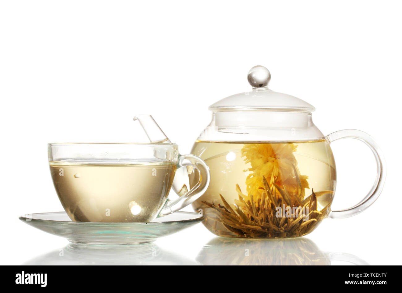 exotic green tea with flowers in glass teapot and cup isolated on white ...