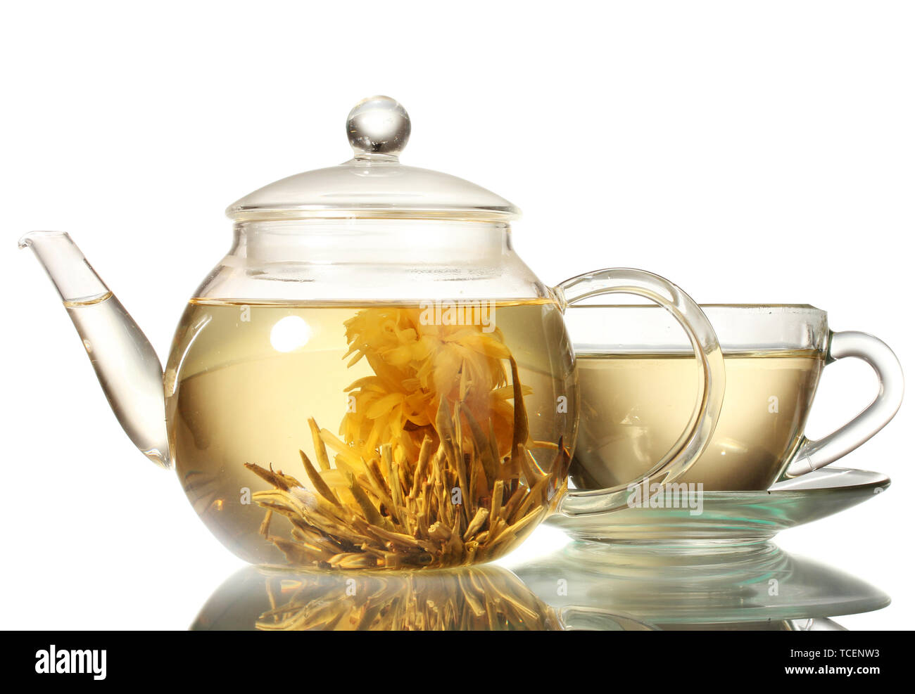 exotic green tea with flowers in glass teapot and cup isolated on white ...