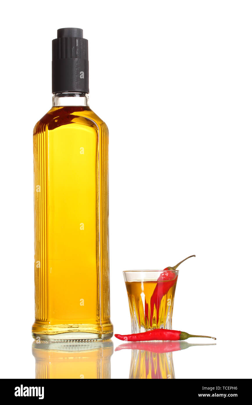 bottle and glass of pepper vodka and red chili peppers isolated on ...