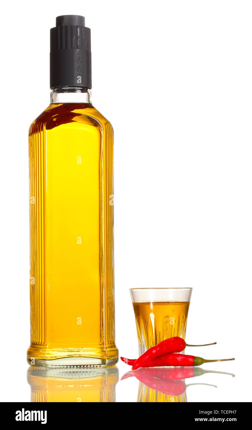 bottle and glass of pepper vodka and red chili peppers isolated on ...