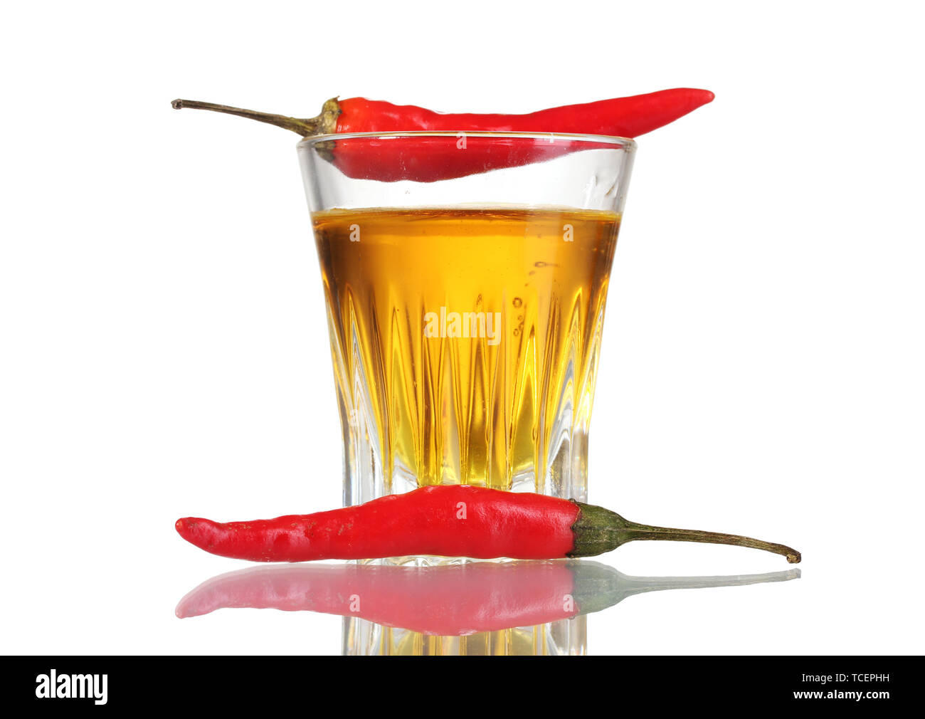 glass of pepper vodka and red chili peppers isolated on white Stock ...