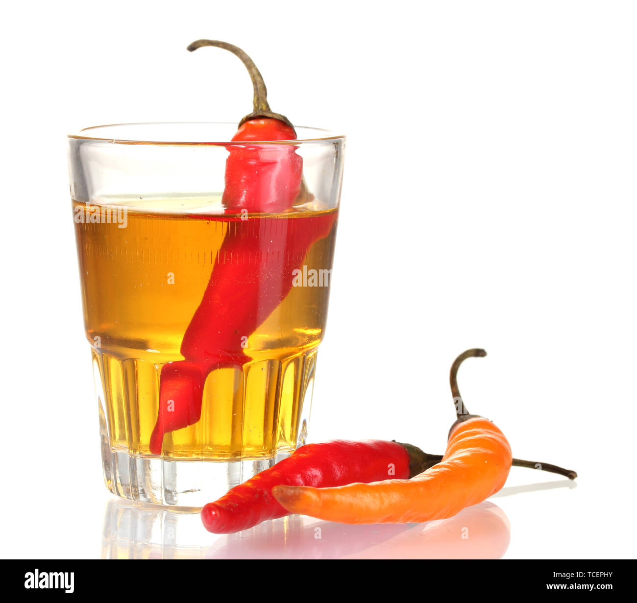 glass of pepper vodka and red chili peppers isolated on white Stock ...