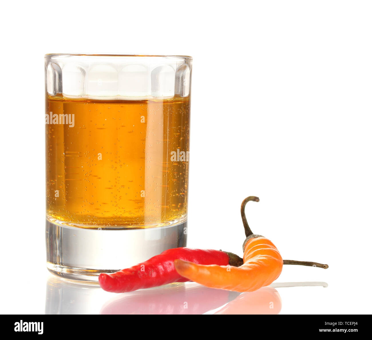 glass of pepper vodka and red chili peppers isolated on white Stock ...