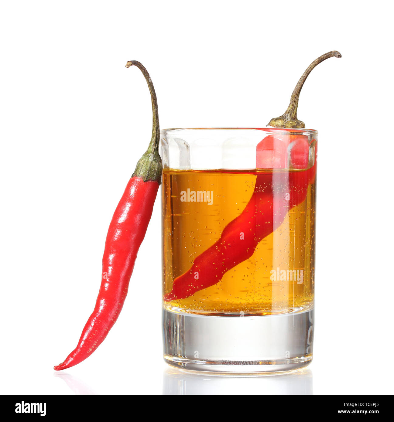 glass of pepper vodka and red chili peppers isolated on white Stock ...
