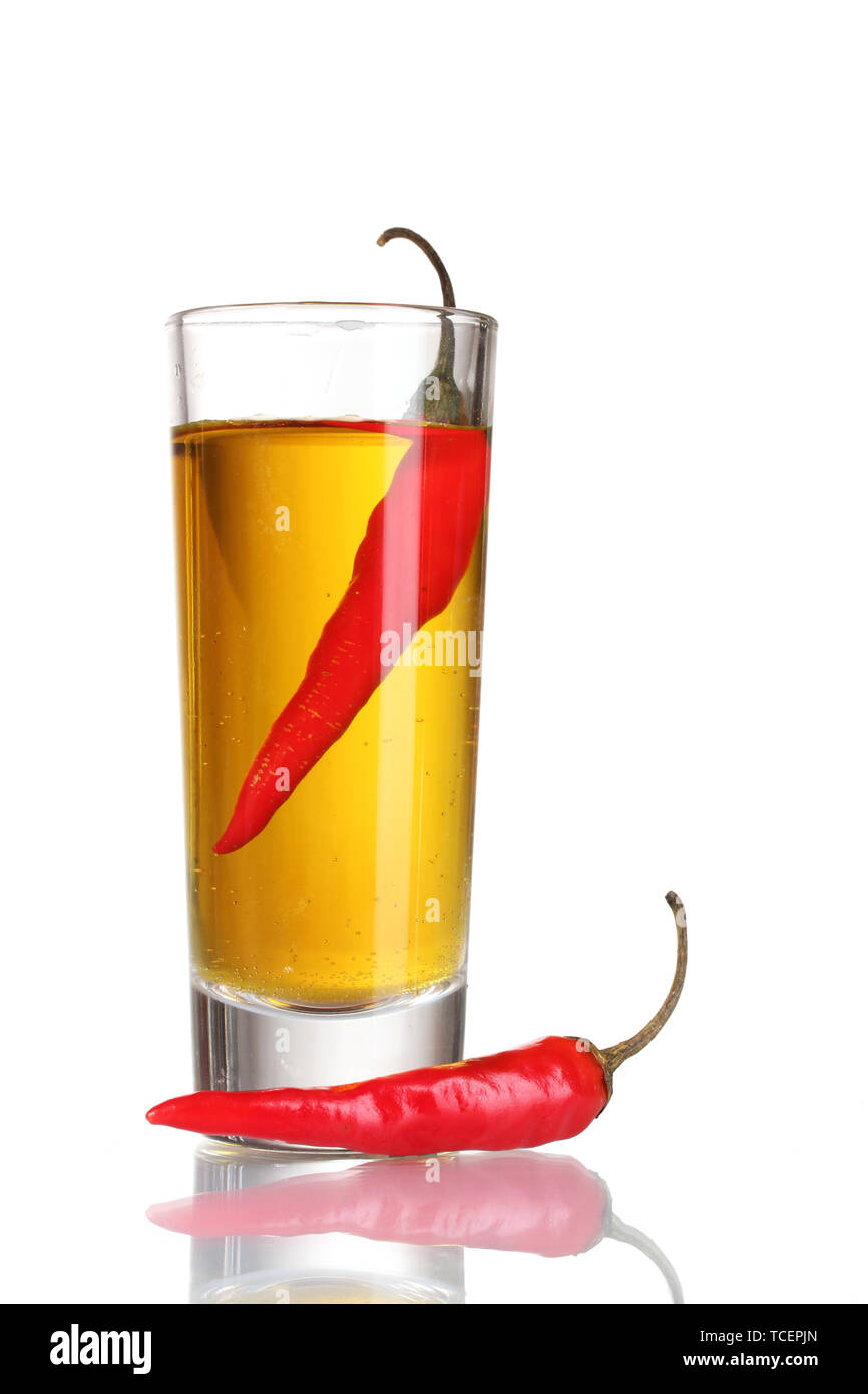 glass of pepper vodka and red chili peppers isolated on white Stock ...