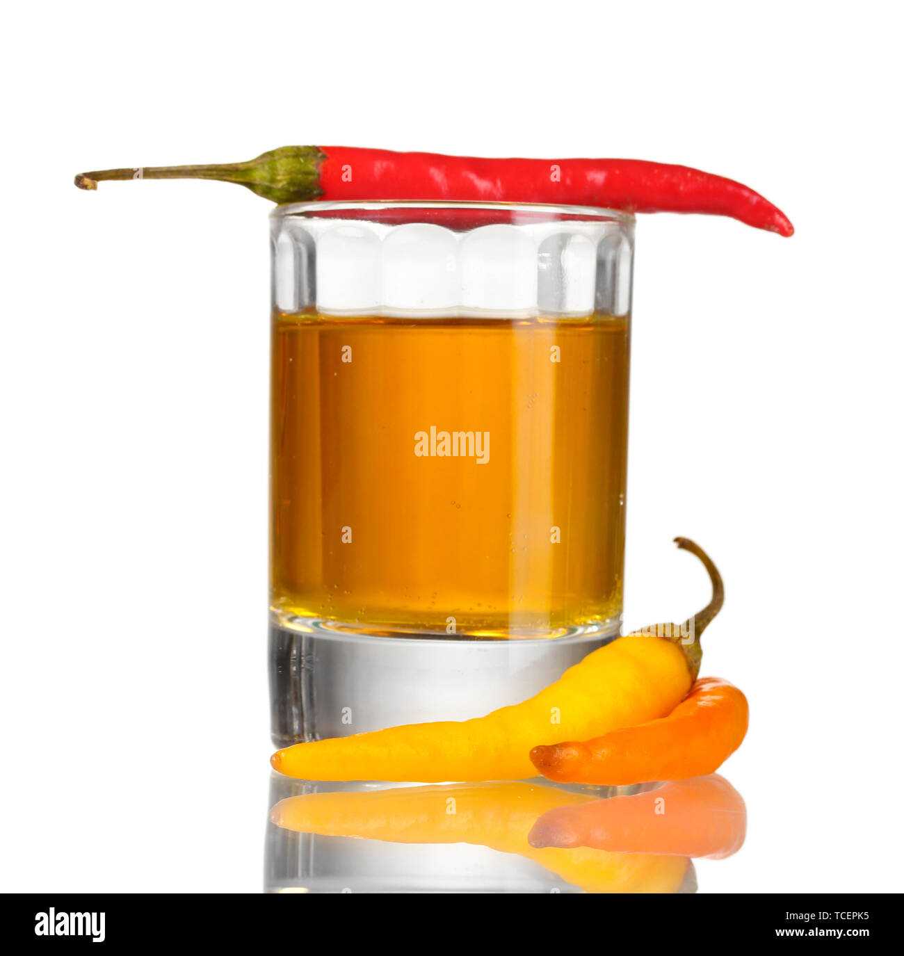 glass of pepper vodka and red chili peppers isolated on white Stock ...