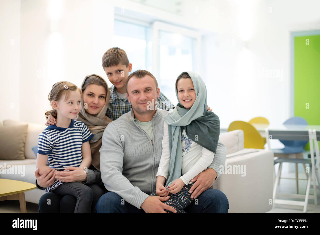portrait of young happy modern muslim family before iftar dinner during ...