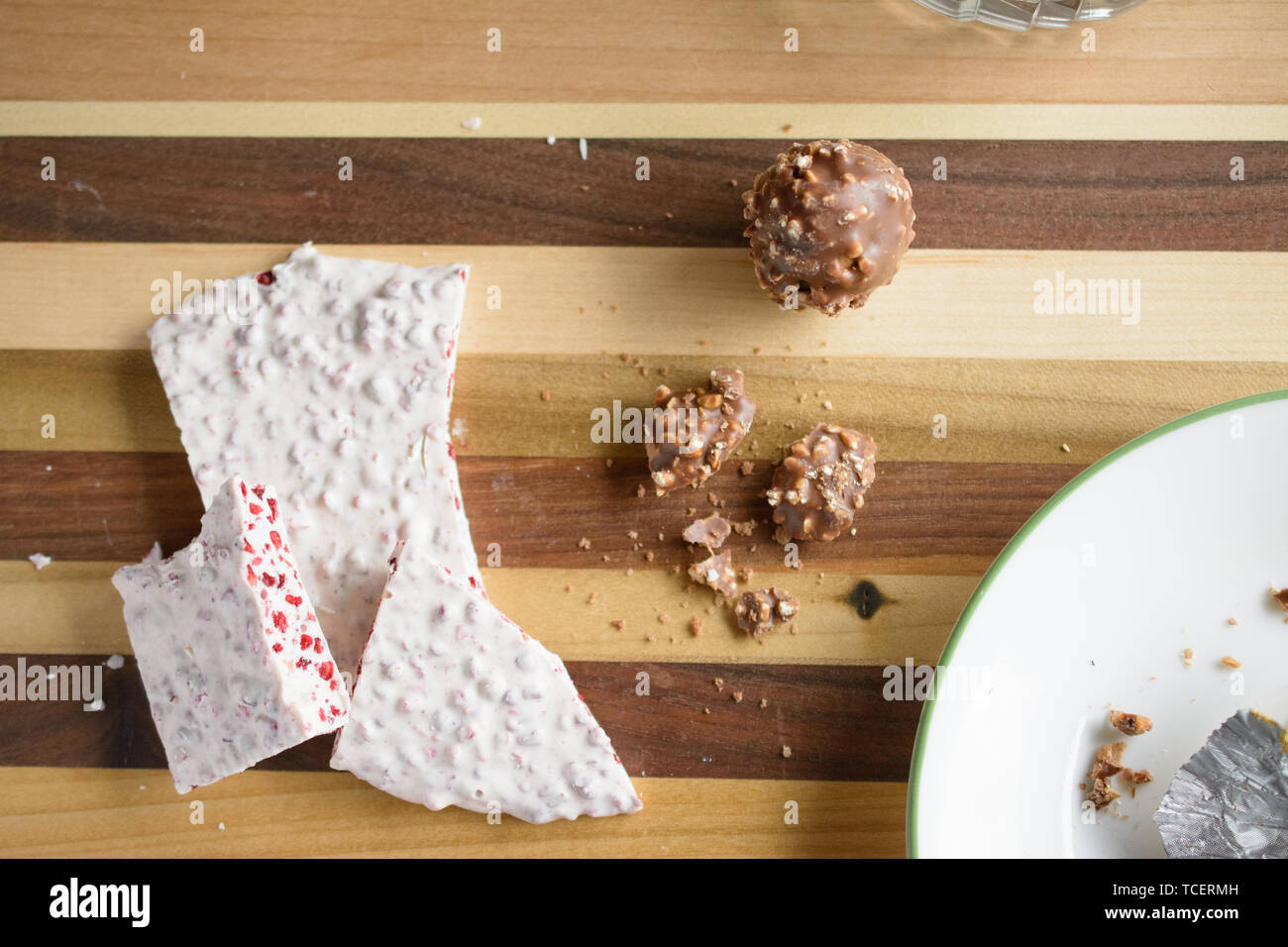 Cracked candies with white and dark hocolate with raspberry and nuts ...