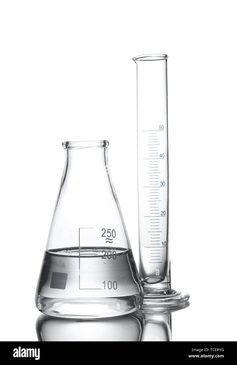 Flask with water and empty measuring beaker with reflection isolated on ...