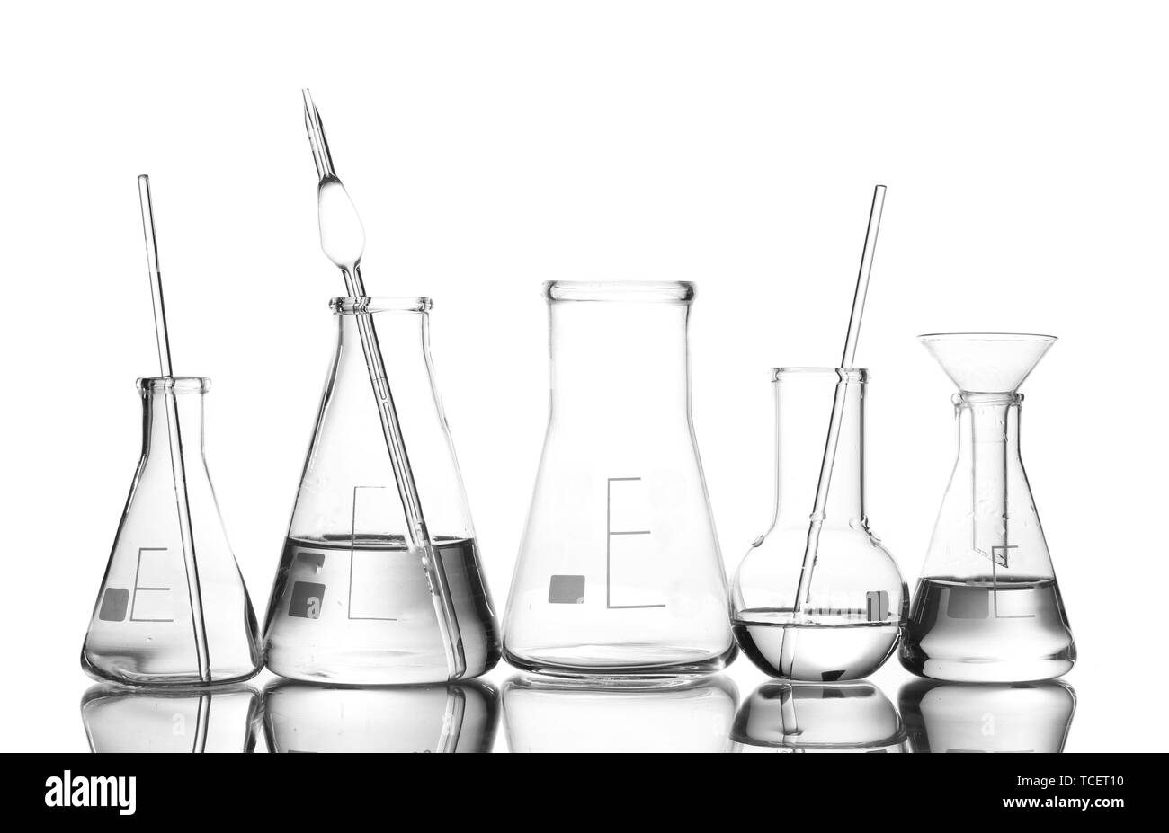 Different laboratory glassware with water and empty with reflection ...
