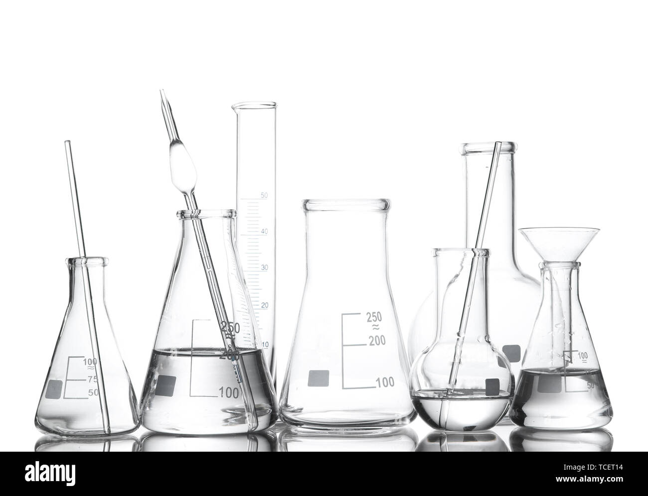 Different laboratory glassware with water and empty with reflection ...