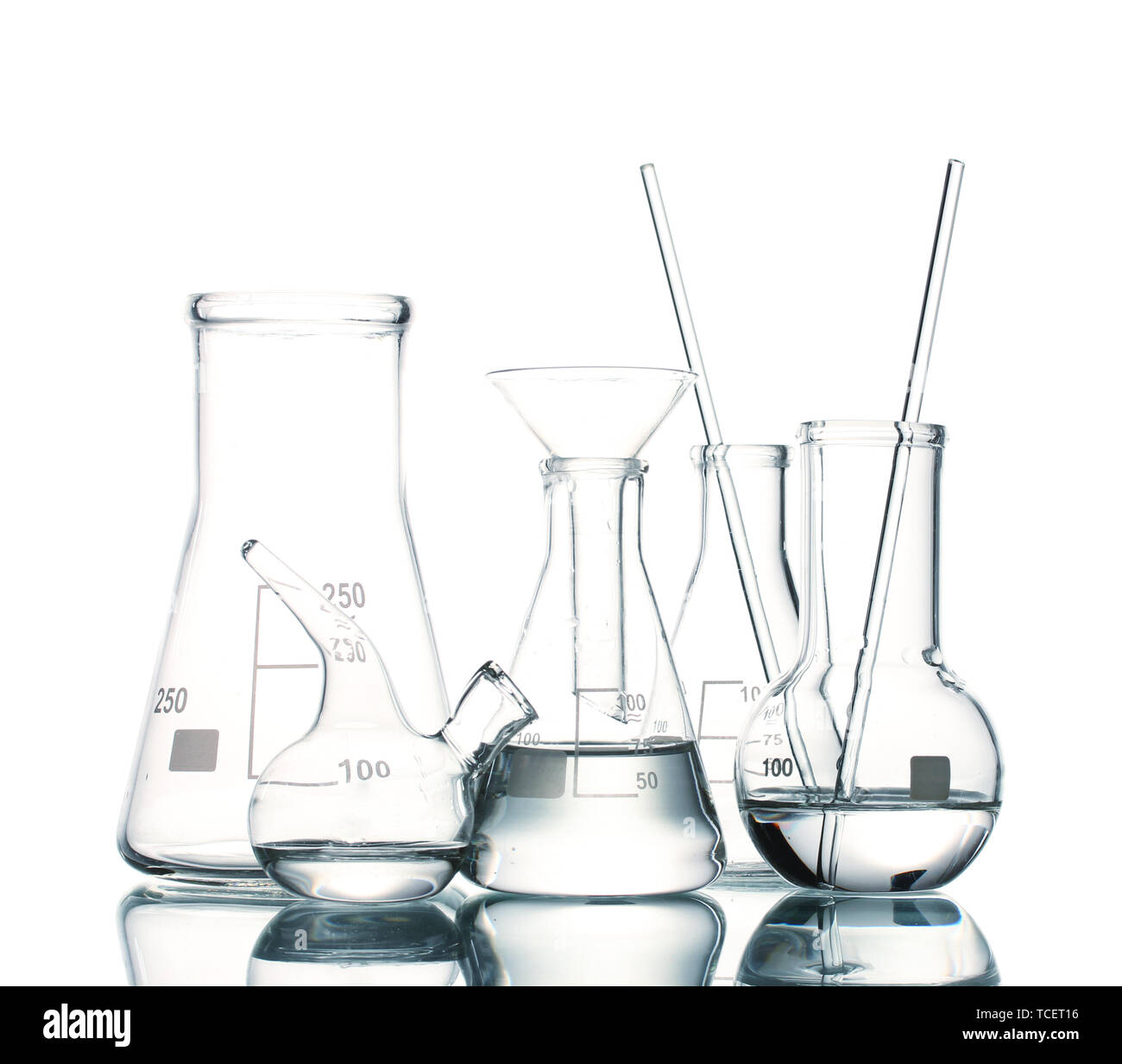 Different laboratory glassware with water and empty with reflection ...