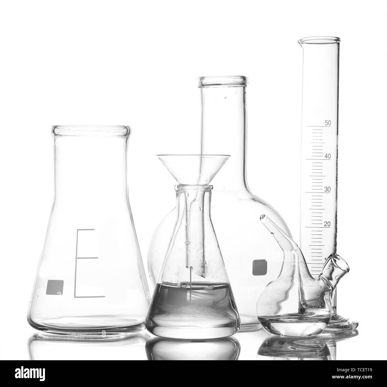 Different laboratory glassware with water and empty with reflection ...