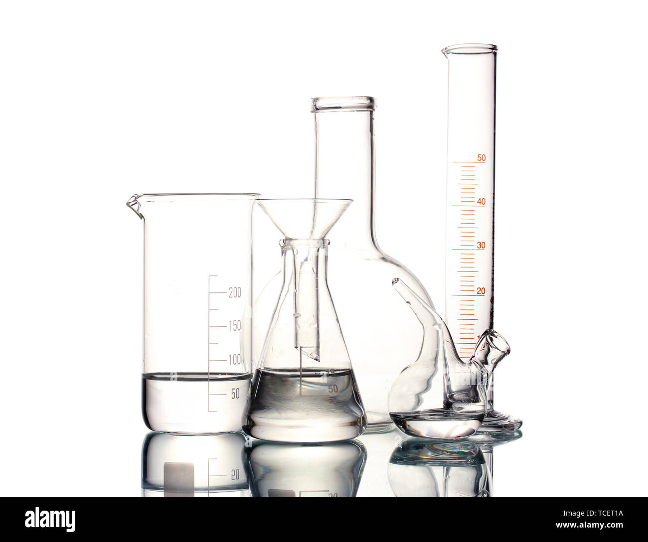 Different laboratory glassware with water and empty with reflection ...