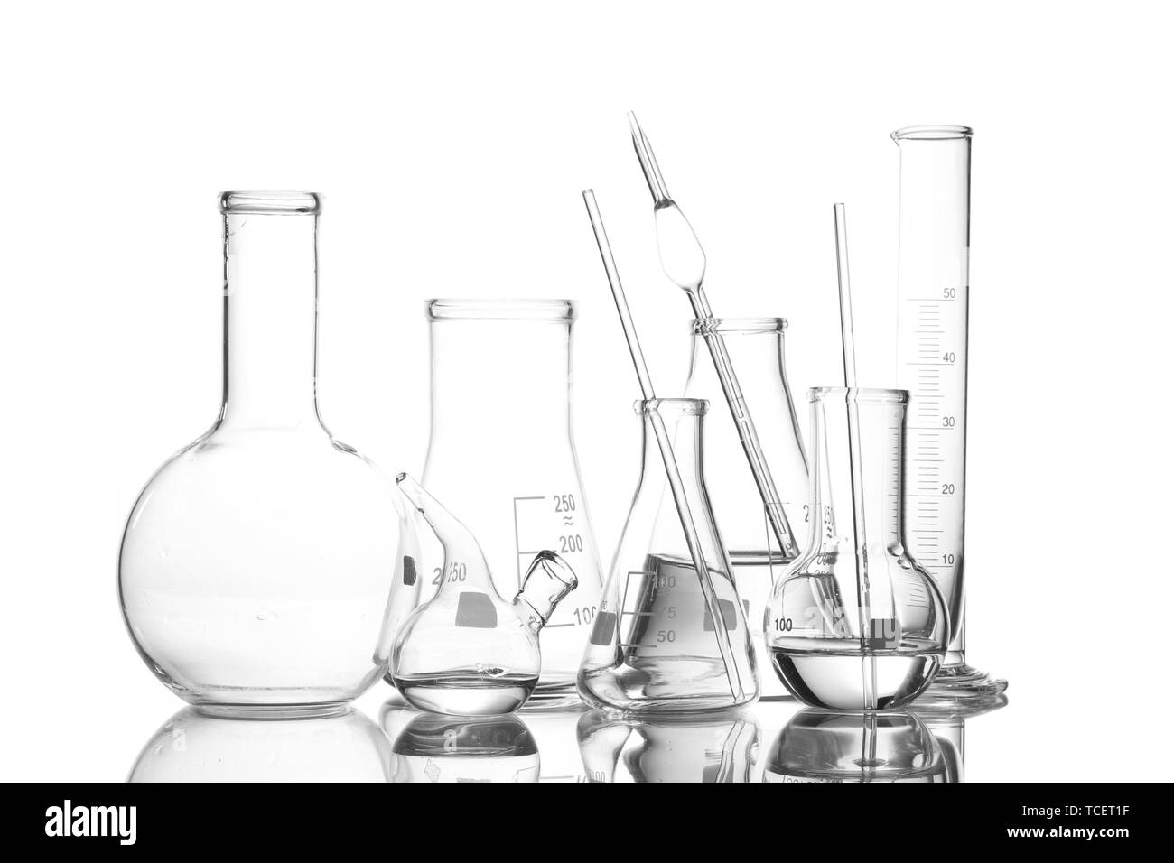 Different laboratory glassware with water and empty with reflection ...