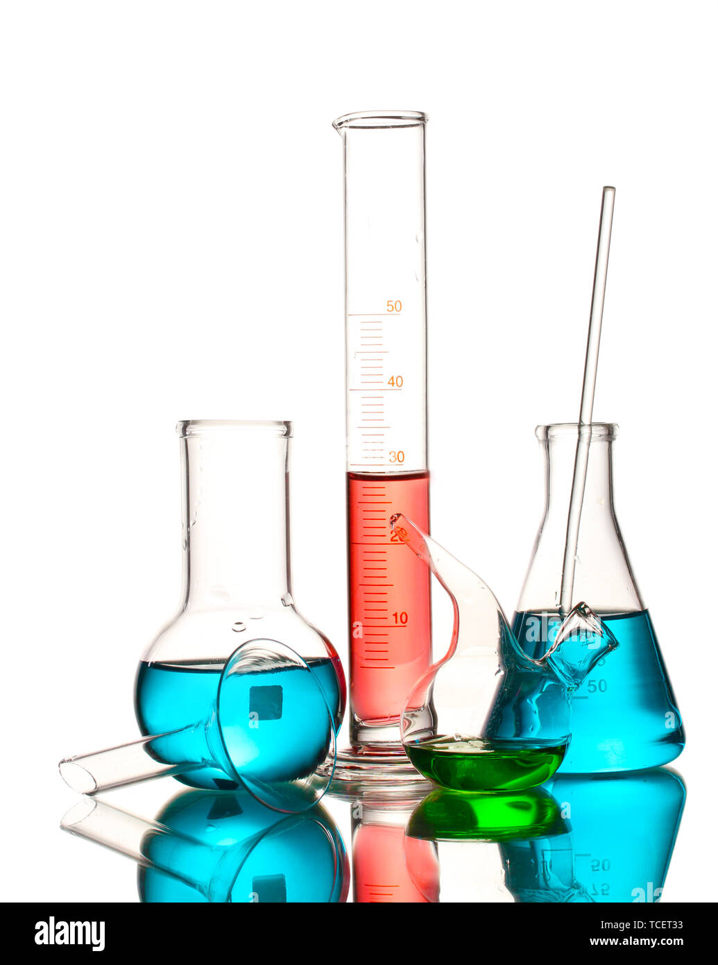 Different laboratory glassware with color liquid and with reflection ...