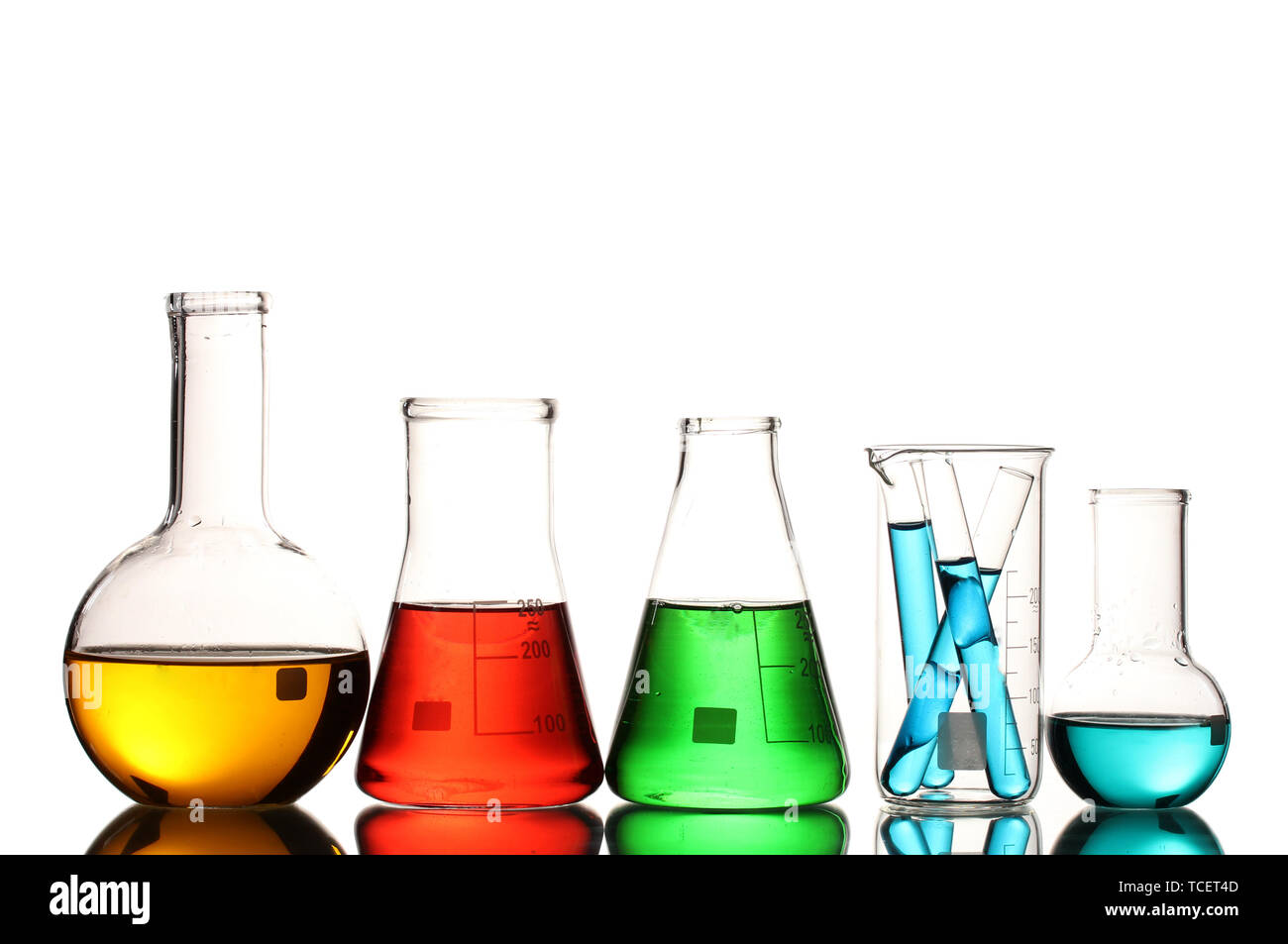 Different laboratory glassware with color liquid and with reflection ...