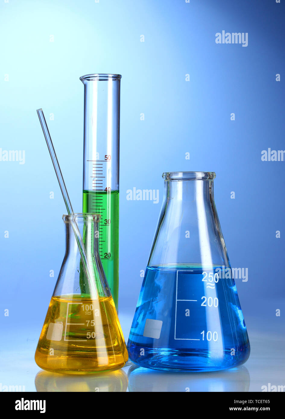 Three flasks with color liquid with reflection on blue background Stock ...