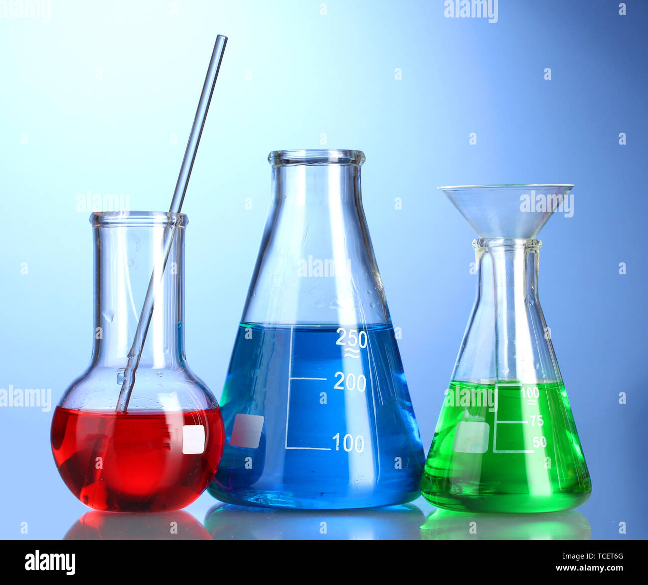 Three flasks with color liquid with reflection on blue background Stock ...