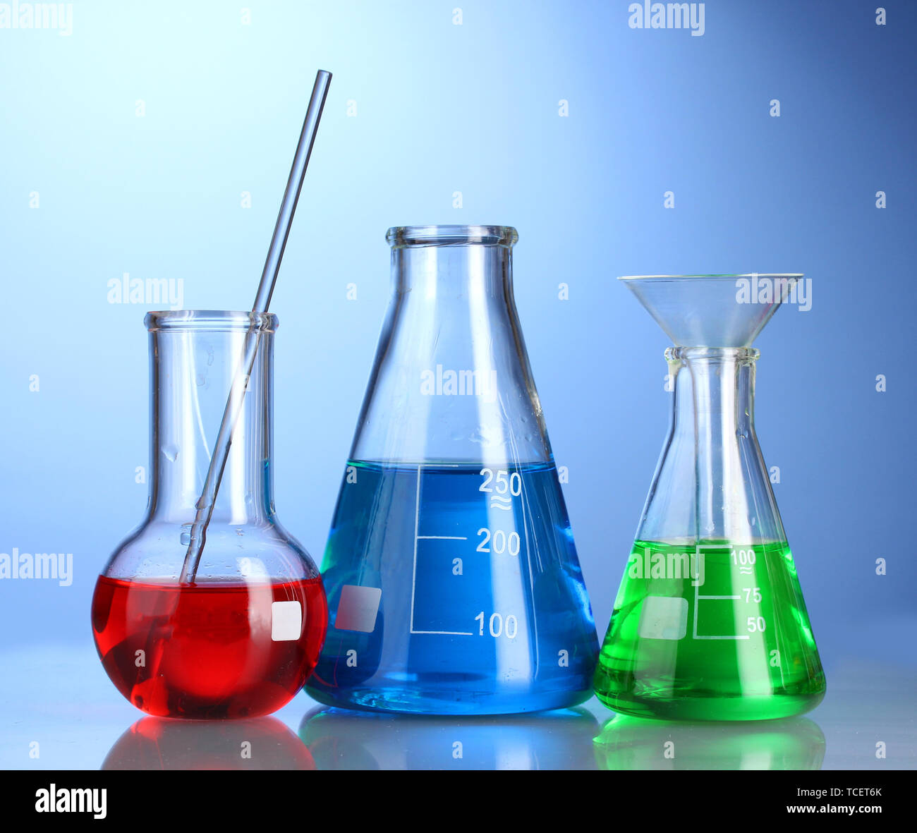 Three flasks with color liquid with reflection on blue background Stock ...