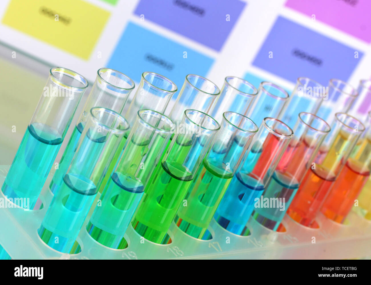 Test-tubes with color liquid on color samples background Stock Photo ...