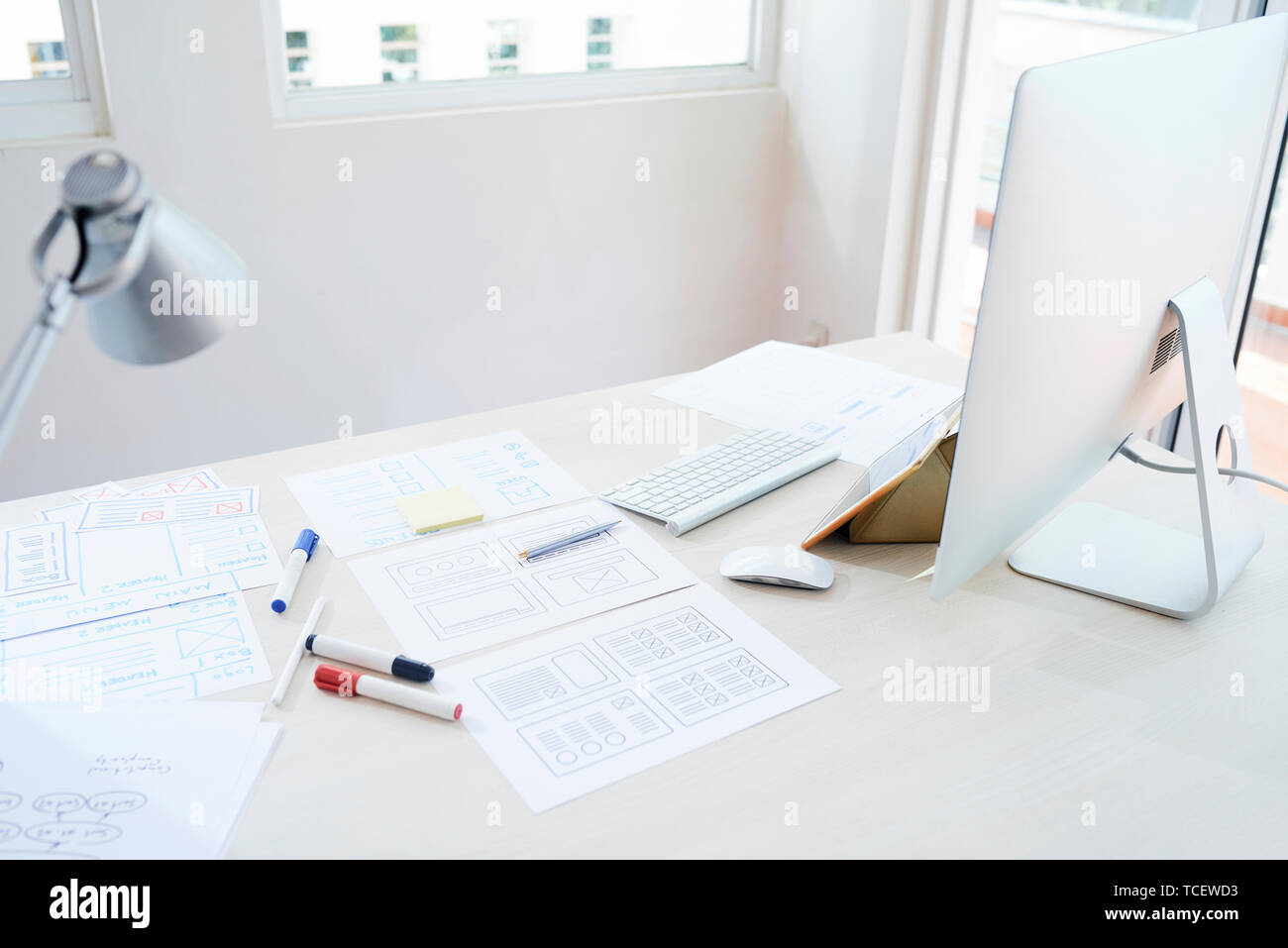 Desk of UI designer or mobile application developer covered with ...