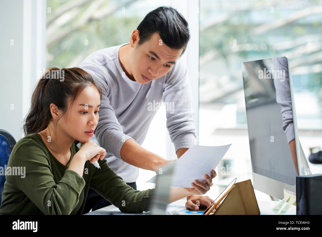 UX designer showing project sketch he made young pensive project ...