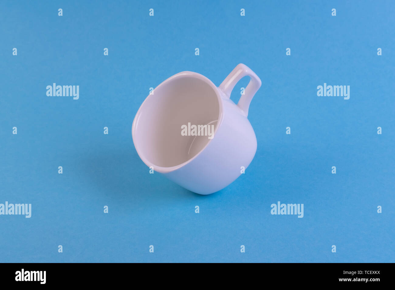 Ceramic isolated coffee mug side view. White teacup on pastel blue ...