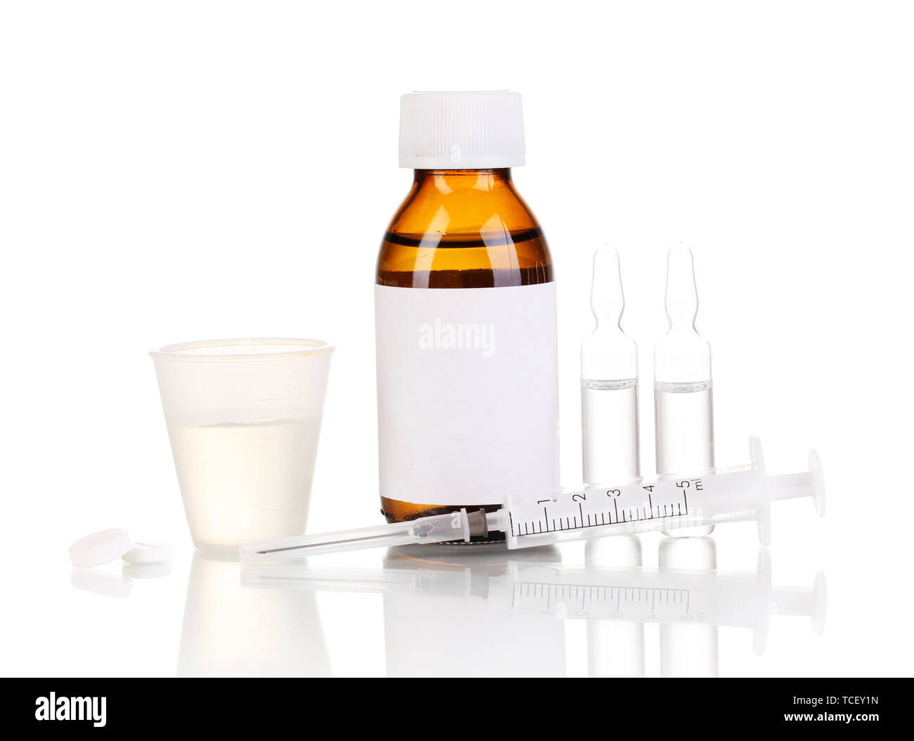 Medical bottle with jigger, tablets, ampoules and syringe isolated on ...