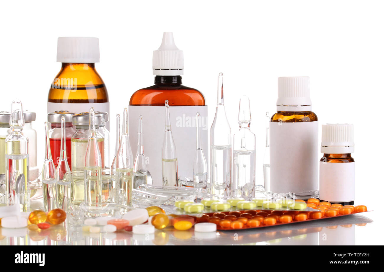 Medical bottles with medical ampoules and tablets isolated on white ...