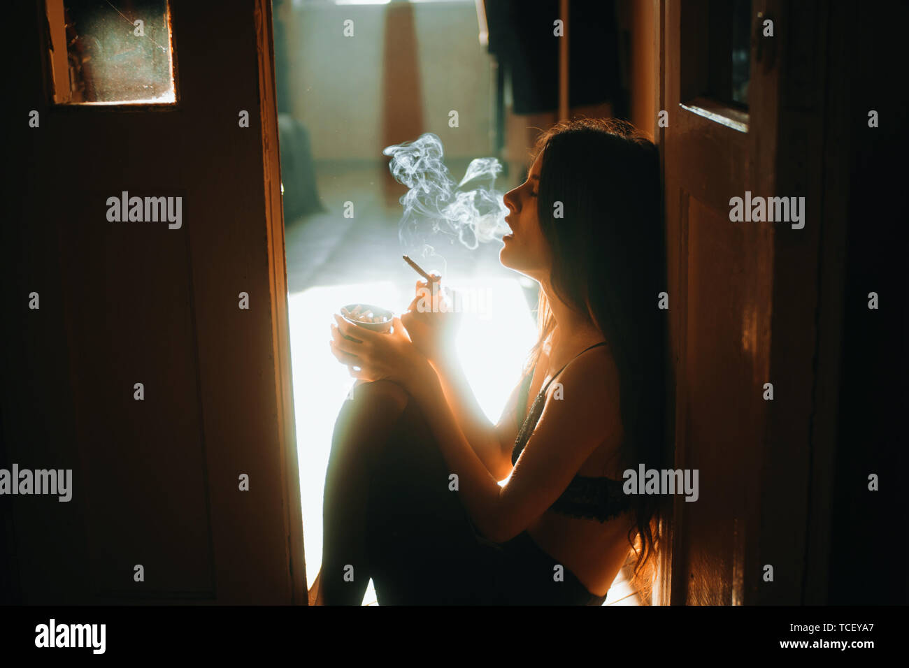 Young beatiful woman lean back on the wall and thinking about herself ...