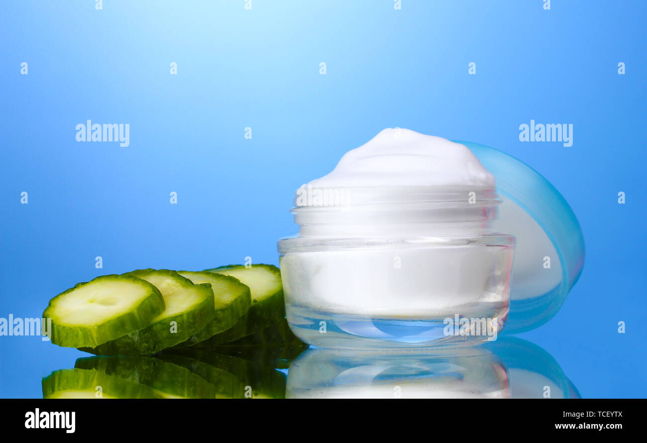 cream and fresh sliced cucumber on blue background Stock Photo - Alamy