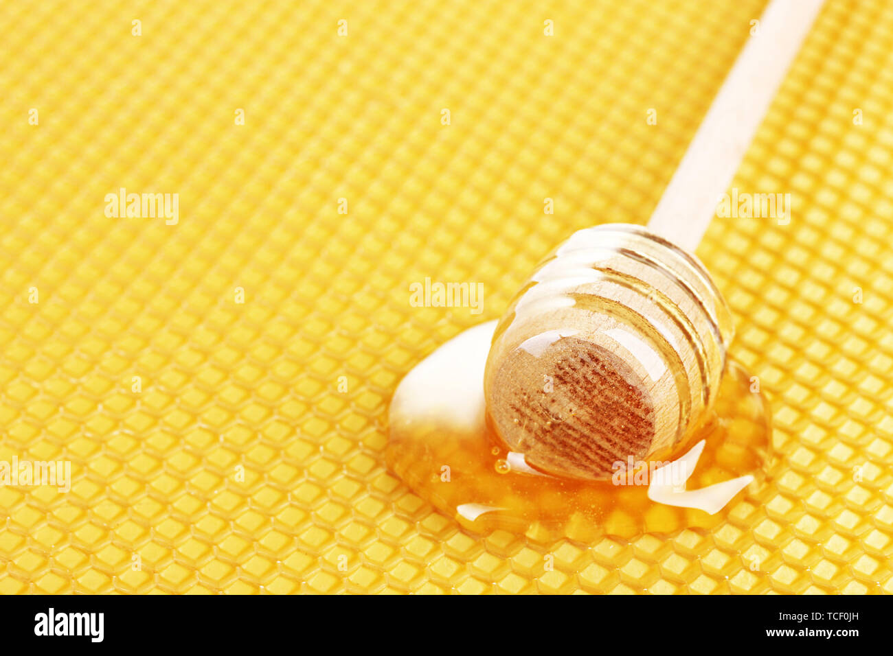 yellow beautiful honeycomb and wooden honey drizzler with honey Stock ...