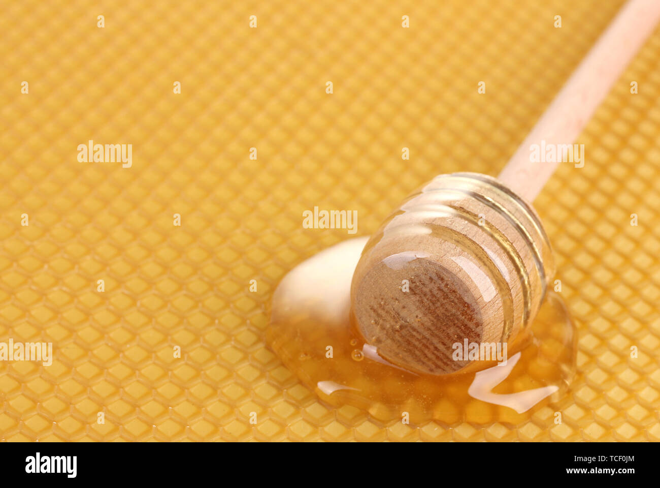 yellow beautiful honeycomb and wooden honey drizzler with honey Stock ...