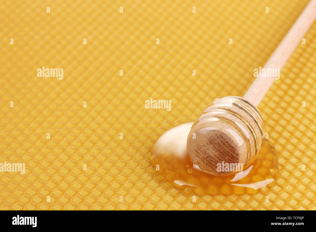 yellow beautiful honeycomb and wooden honey drizzler with honey Stock ...