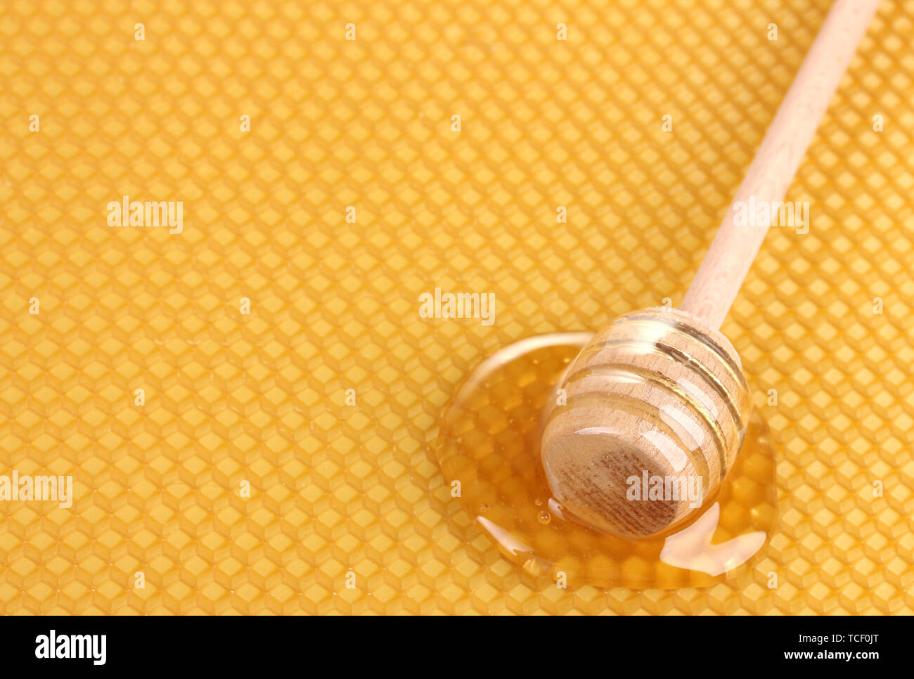 yellow beautiful honeycomb and wooden honey drizzler with honey Stock ...