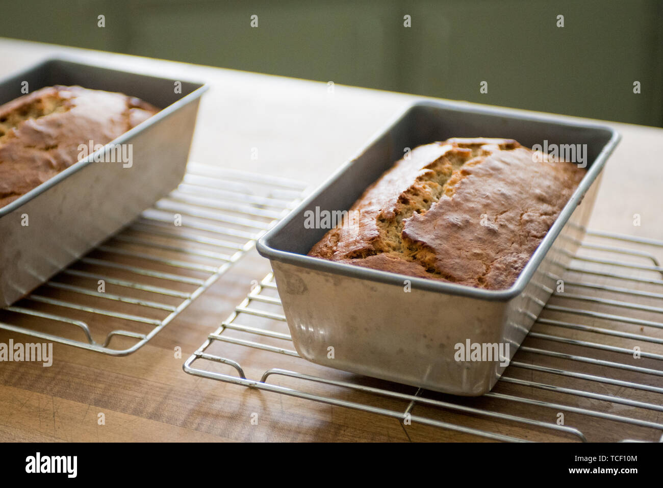 Metal forms on cooling racks with freshly baked buns of bread Stock ...