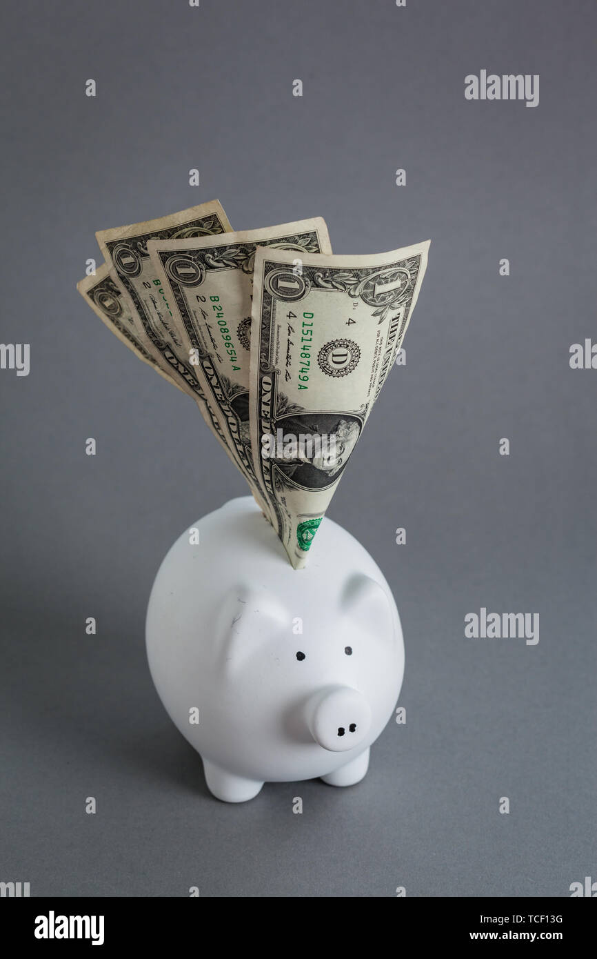 Huge savings in the piggy bank, overflowing with cash Stock Photo - Alamy