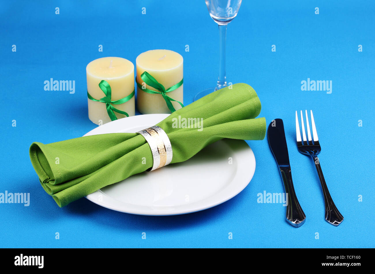 Table setting on blue background Stock Photo - Alamy
