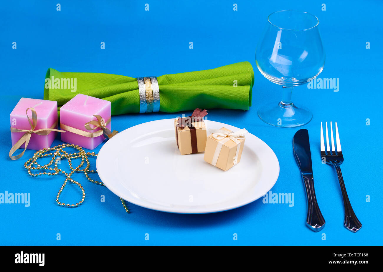 Table setting on blue background Stock Photo - Alamy