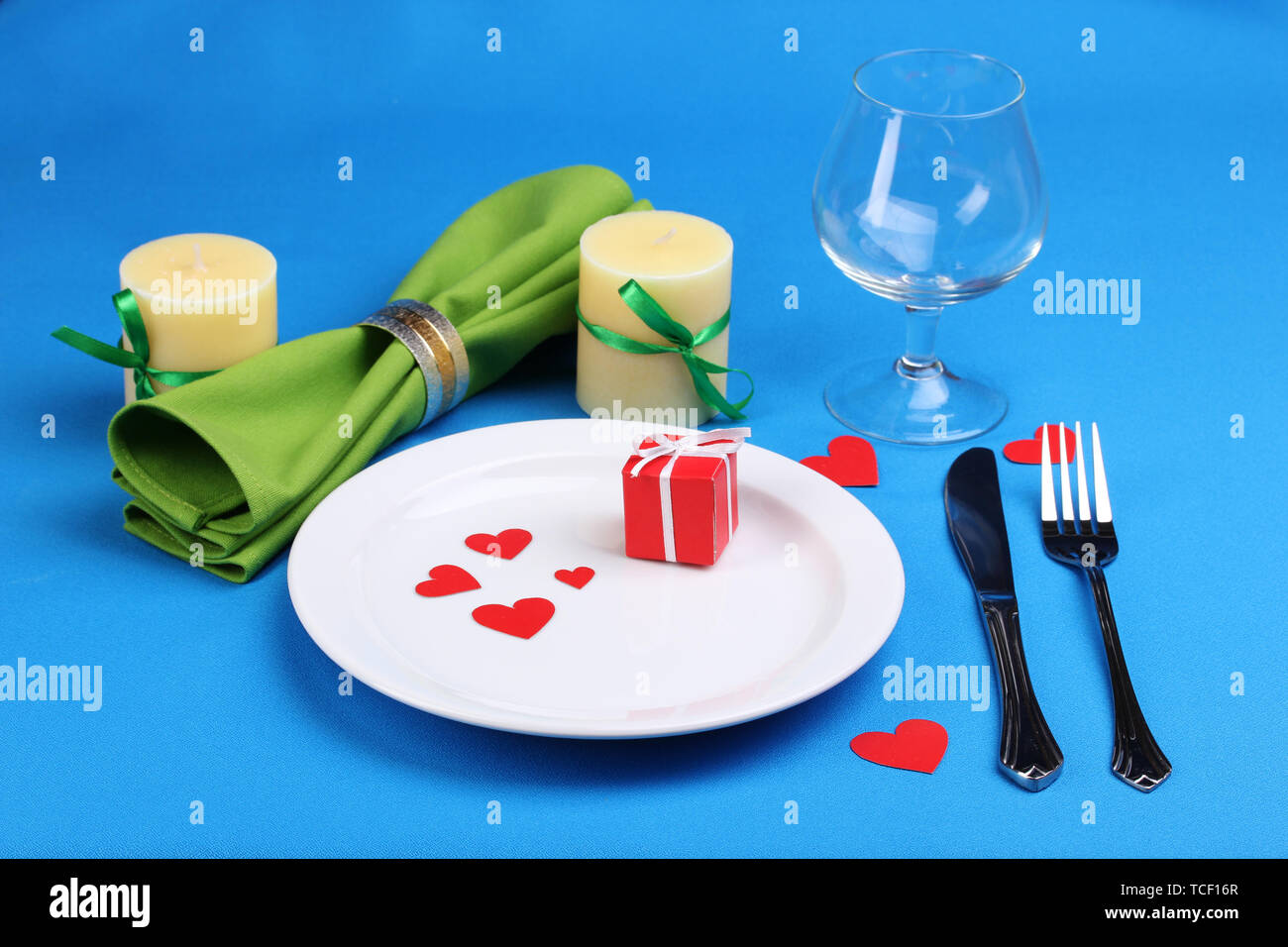 Table setting on blue background Stock Photo - Alamy