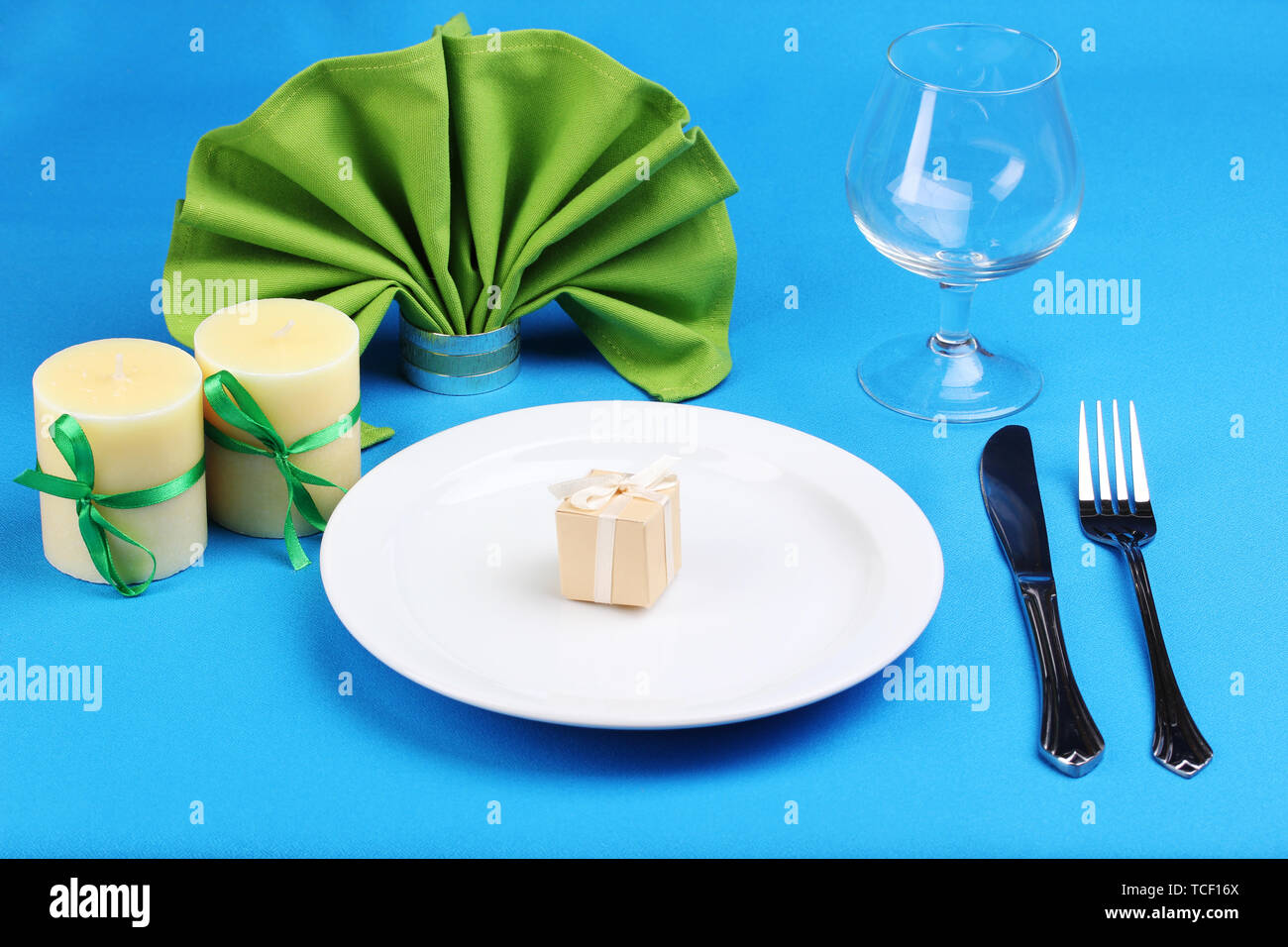 Table setting on blue background Stock Photo - Alamy