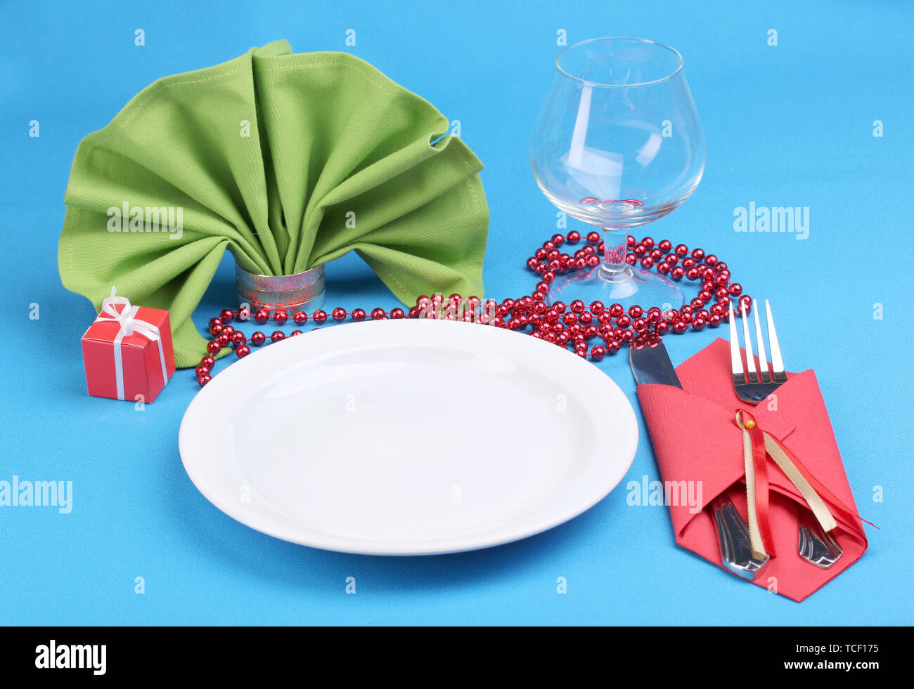 Table setting on blue background Stock Photo - Alamy