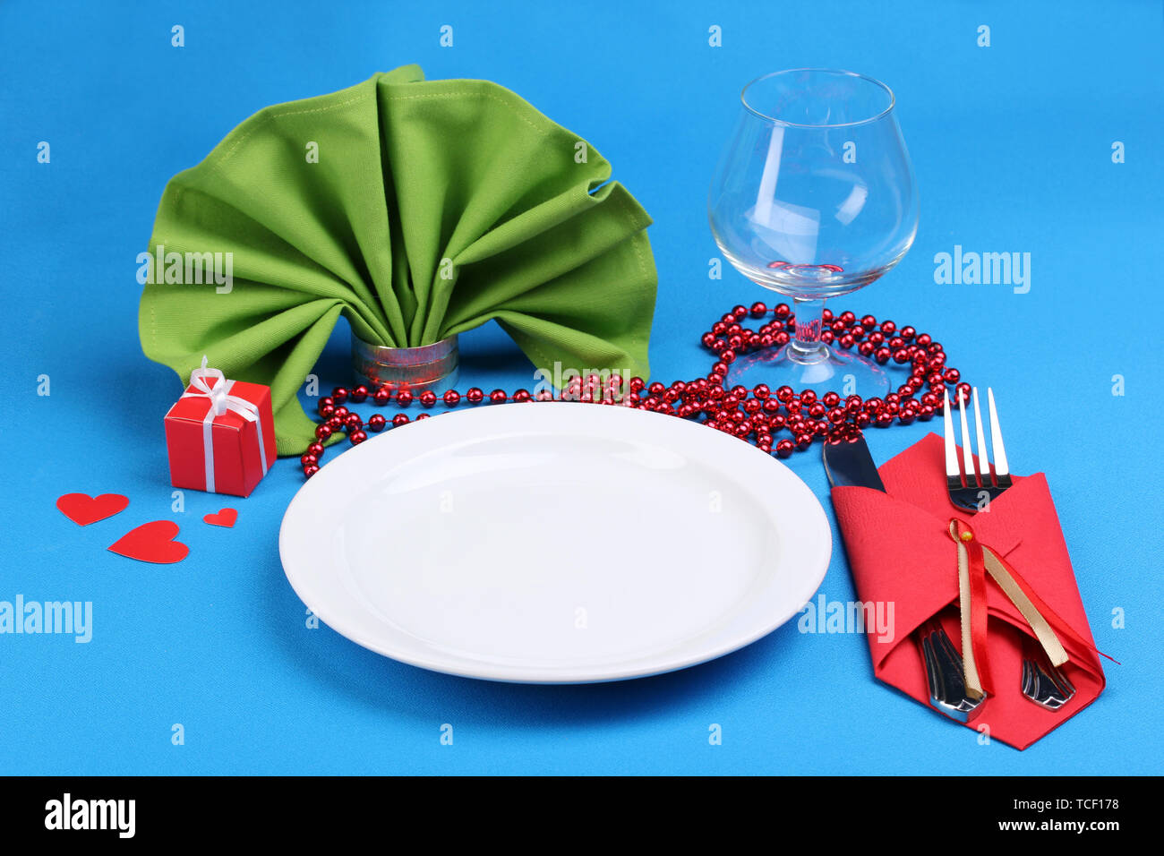 Table setting on blue background Stock Photo - Alamy