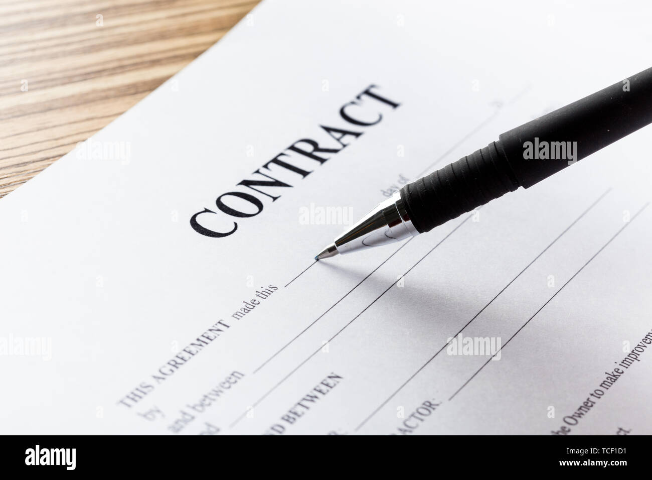 Pen and contract papers on wooden desk Stock Photo - Alamy
