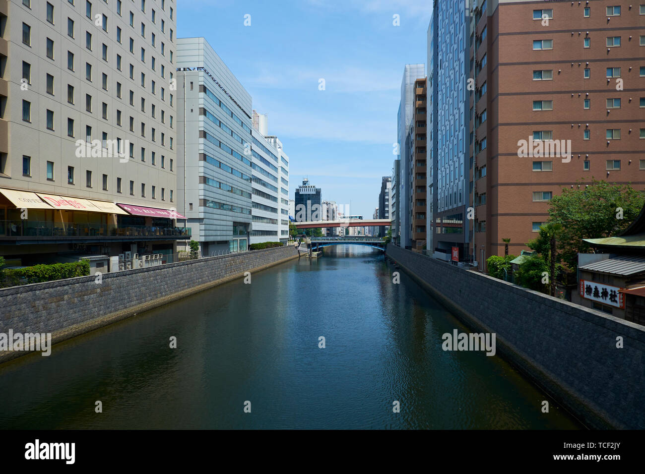 Looking down one of the many canals that flow through Tokyo in Japan ...